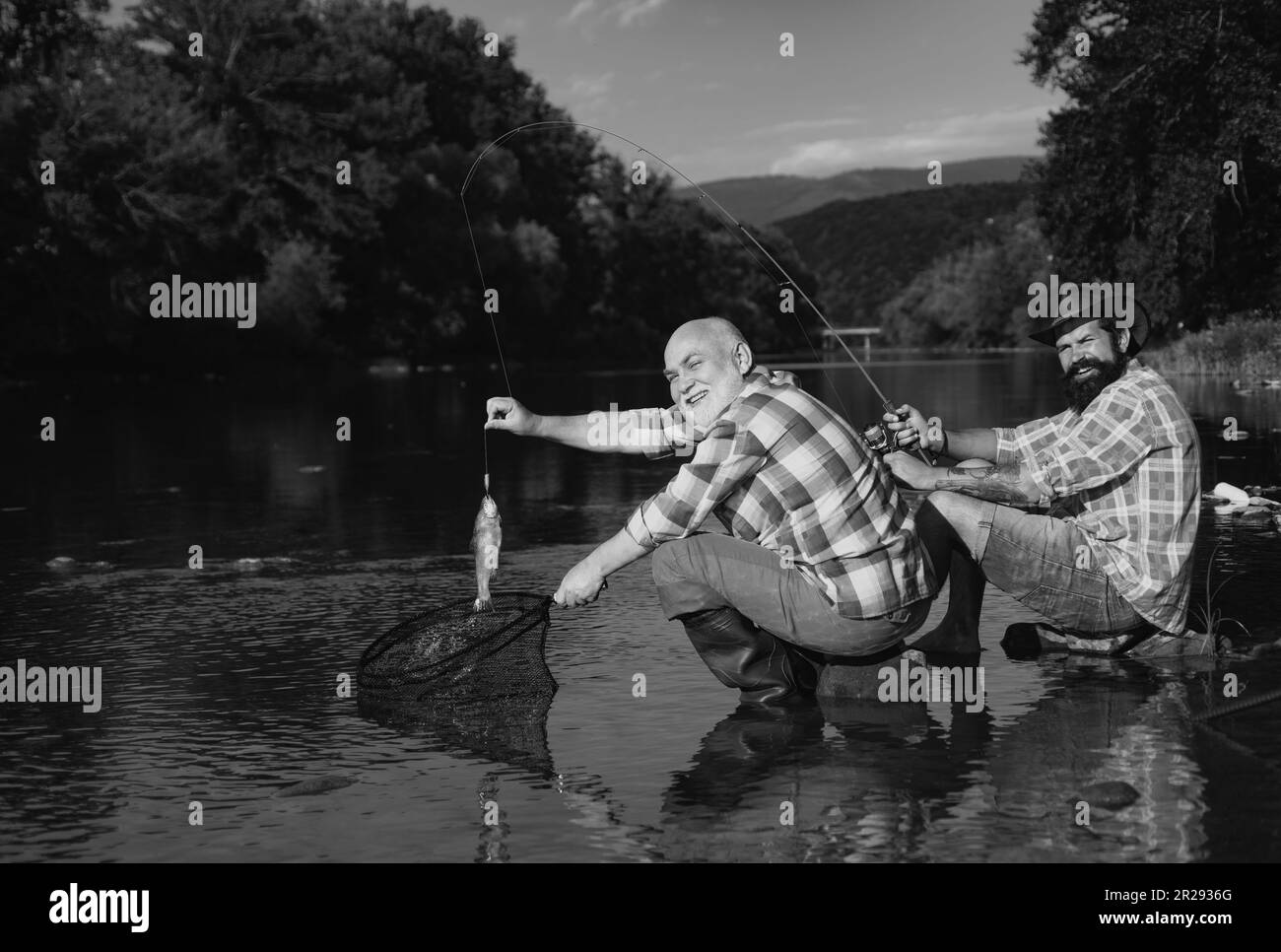 Two men friends fisherman Black and White Stock Photos & Images - Alamy
