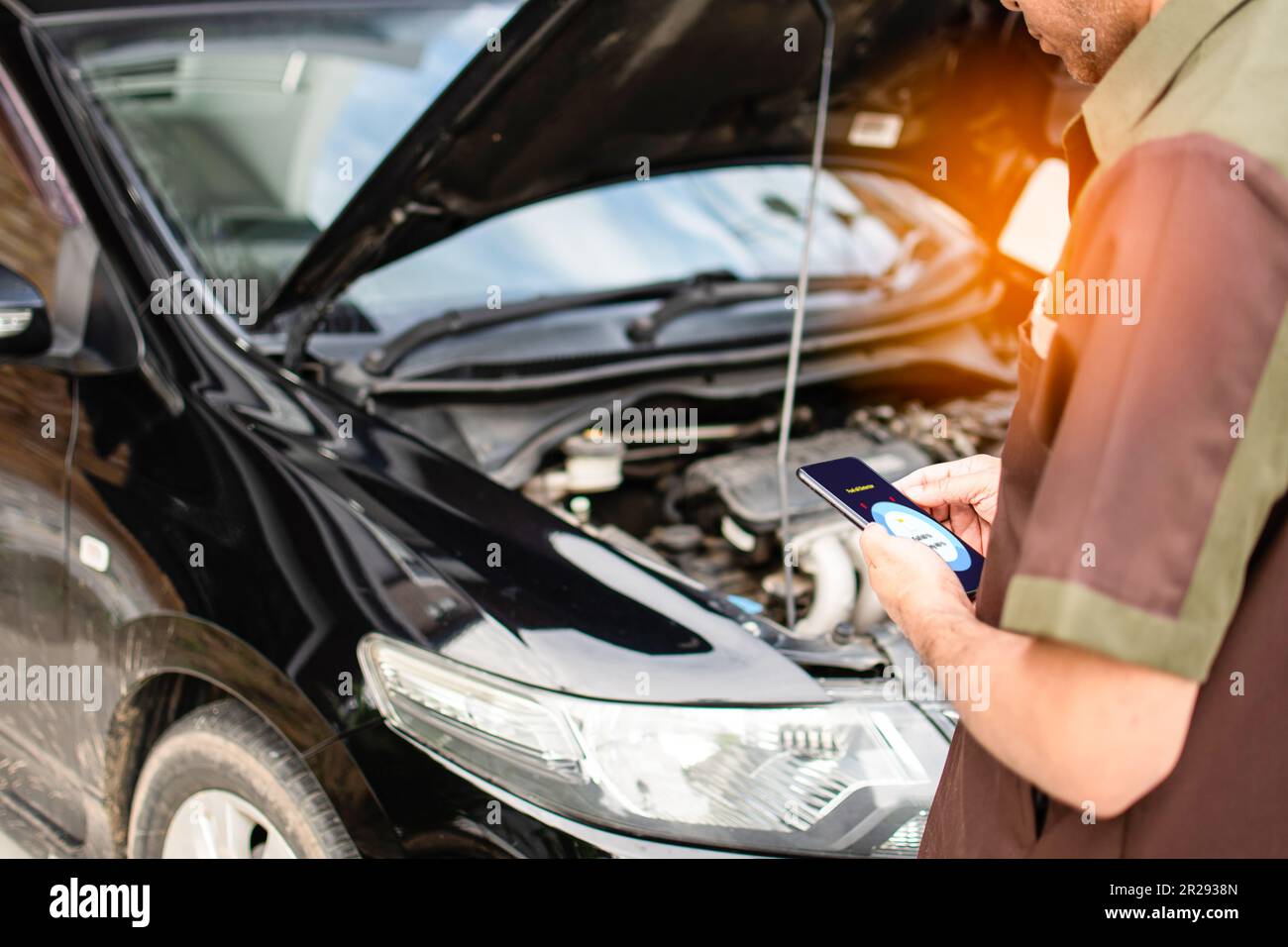 Technician holding smartphone to watch the oil function monitor. Mobile ...