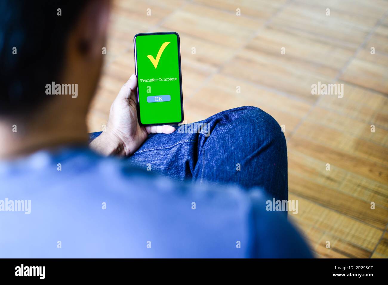 The smartphone screen displays a transfer payment message to confirm ...