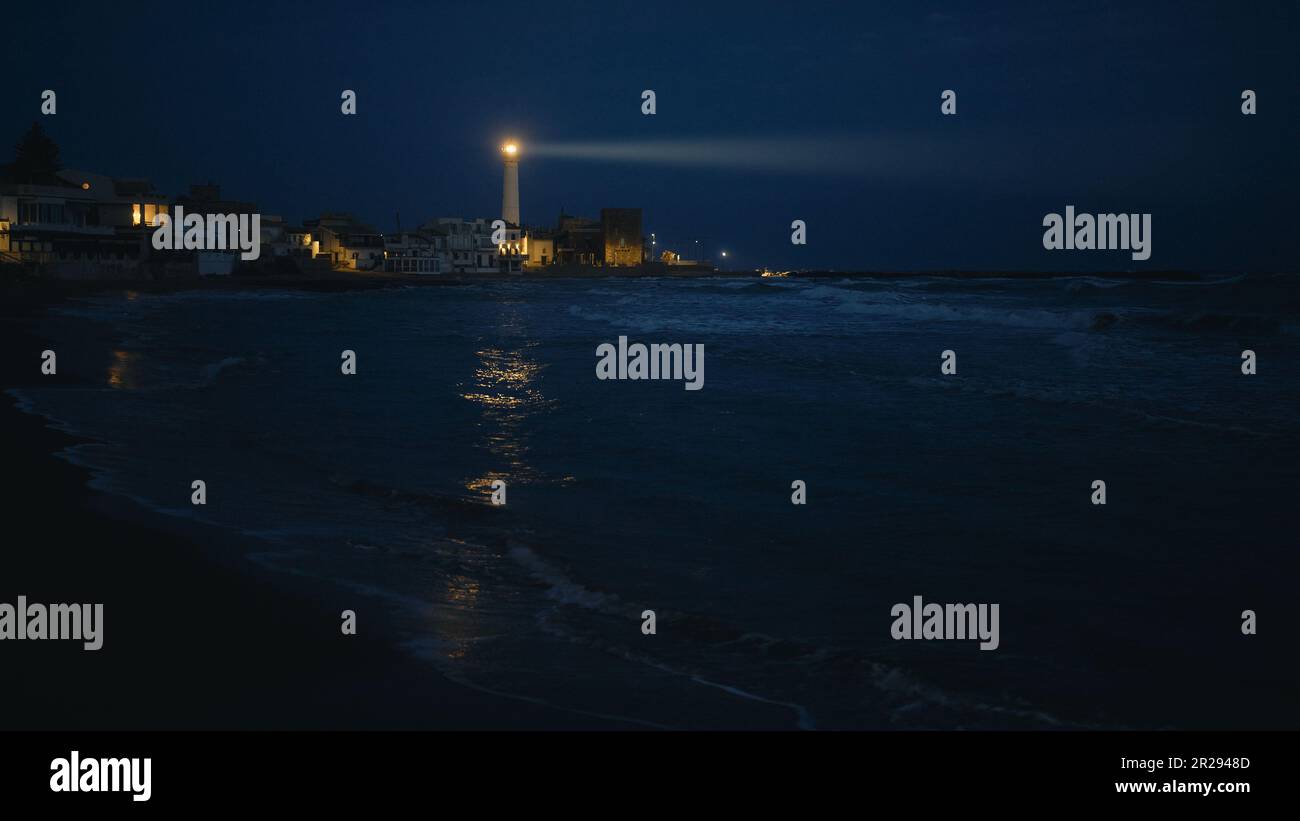 Lighthouse tower flashes at night Stock Photo - Alamy
