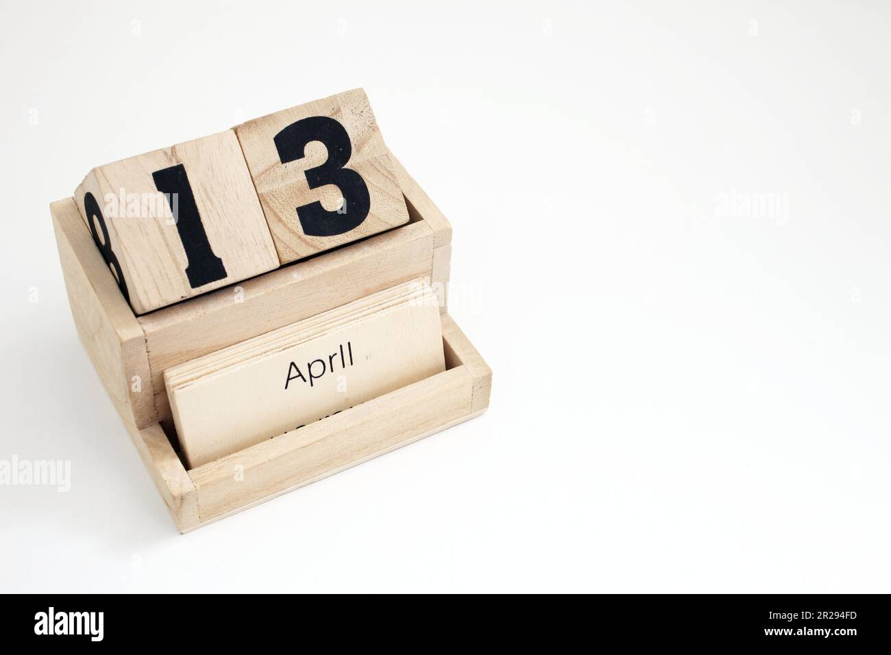 Wooden perpetual calendar showing the 13th of April Stock Photo - Alamy