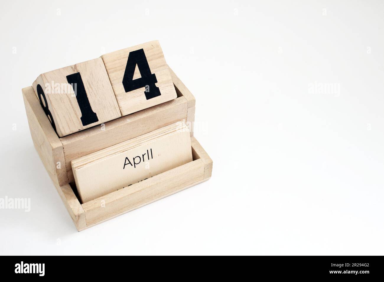 Wooden perpetual calendar showing the 14th of April Stock Photo - Alamy