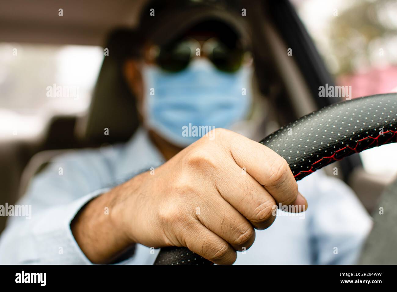 Daylight a man driving two hands to hold the steering wheel to control ...