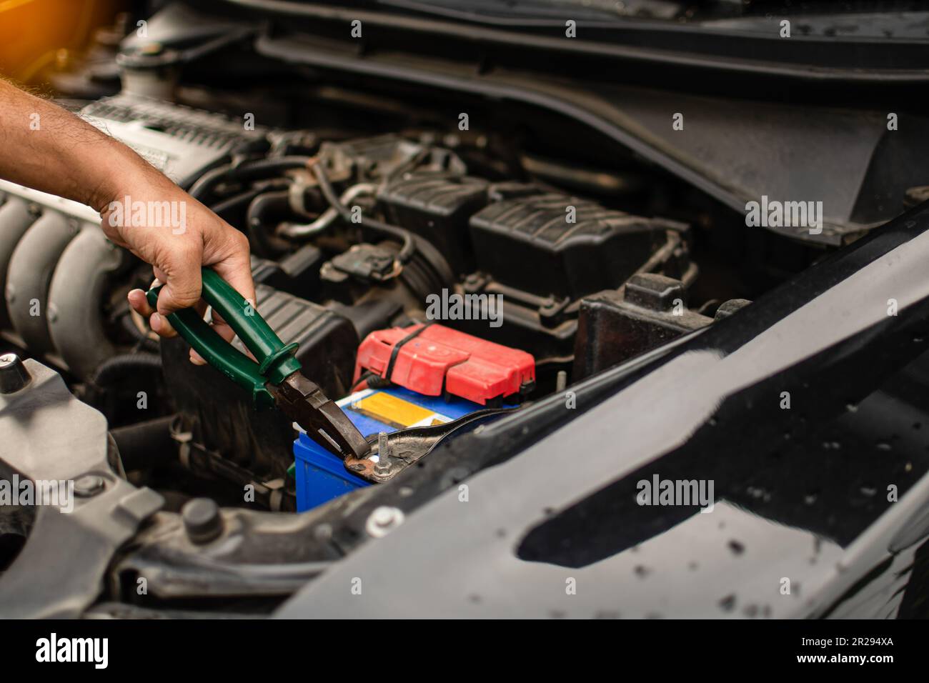 Closeup, The hands of a male technician are using a tool to replace the ...