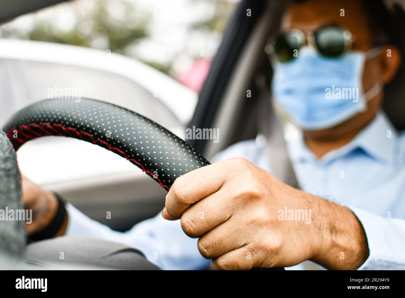 Daylight a man driving two hands to hold the steering wheel to control ...