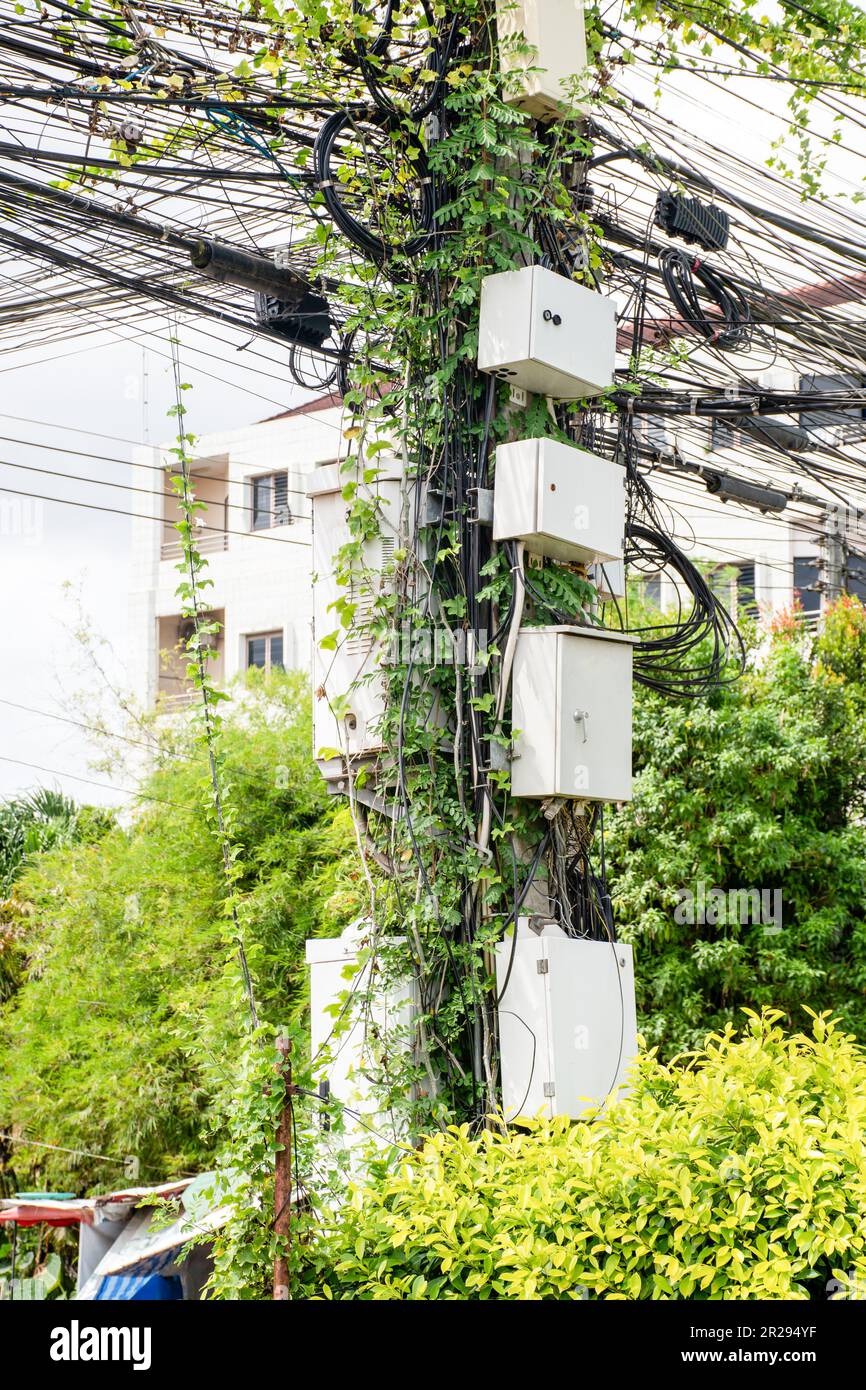 Mess of electric cables and telephone wires hi-res stock photography ...