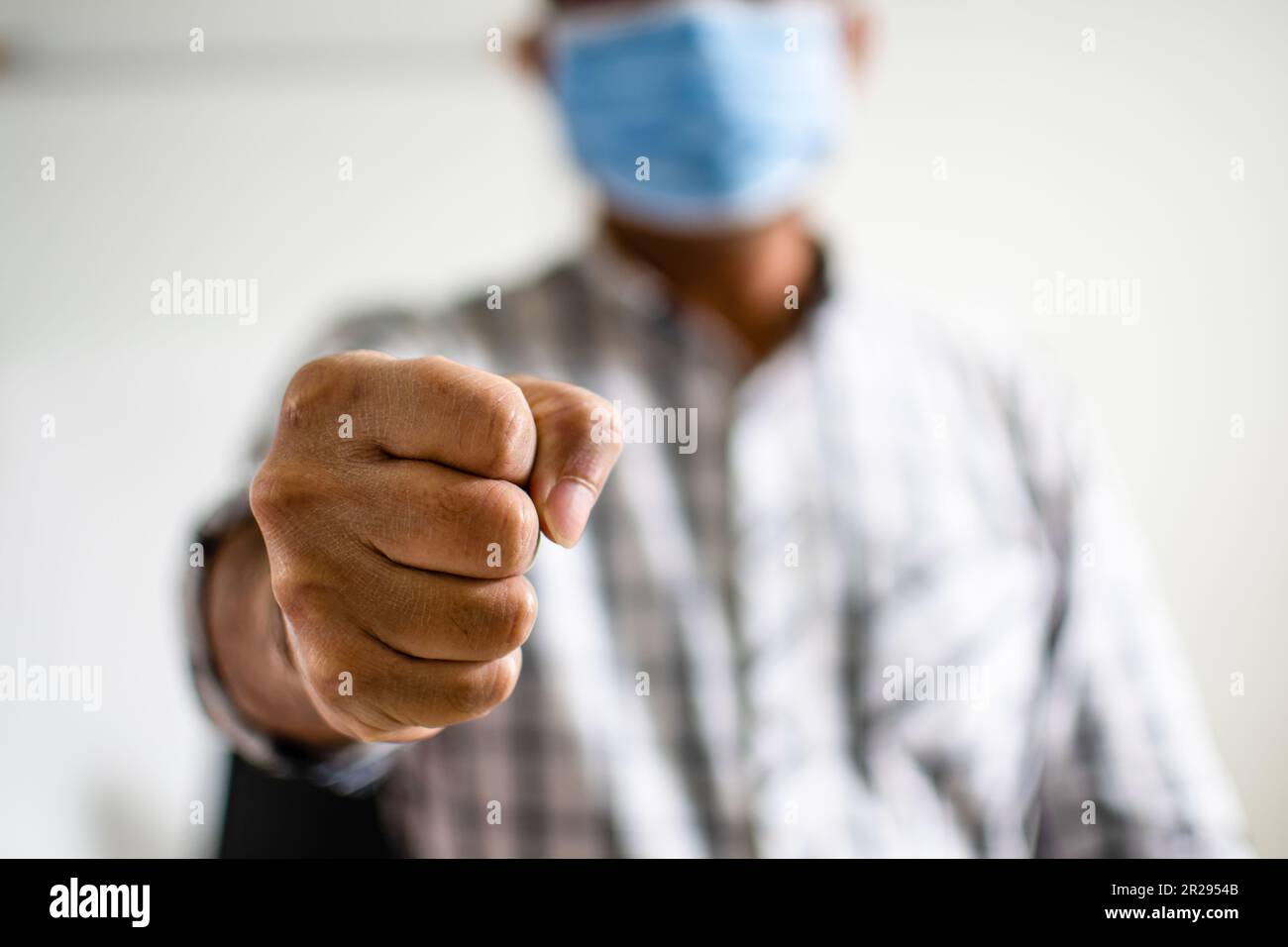 A young male is standing and fist clenched in anger. One man at home ...