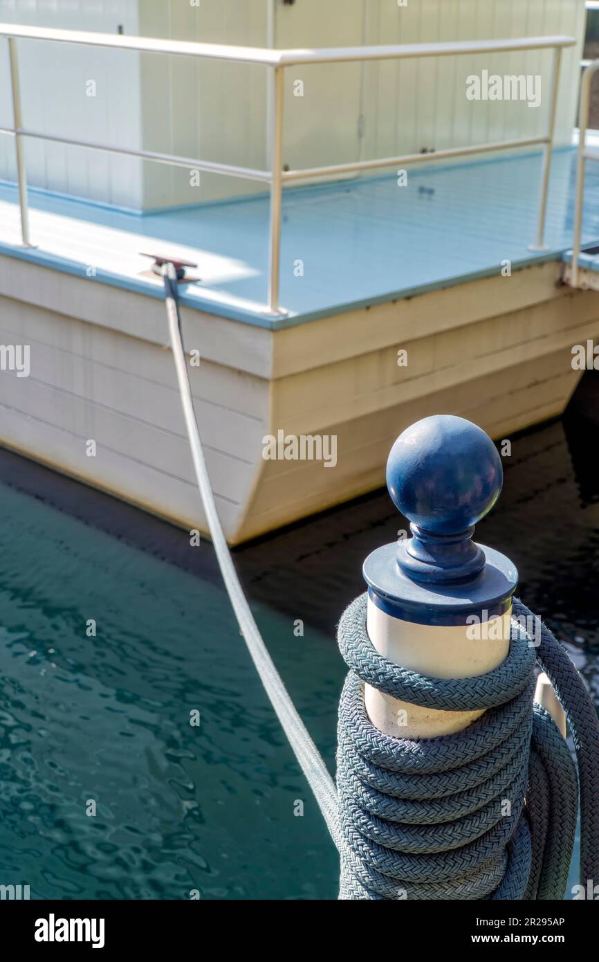 A boat tied with blue rope to pier Stock Photo - Alamy
