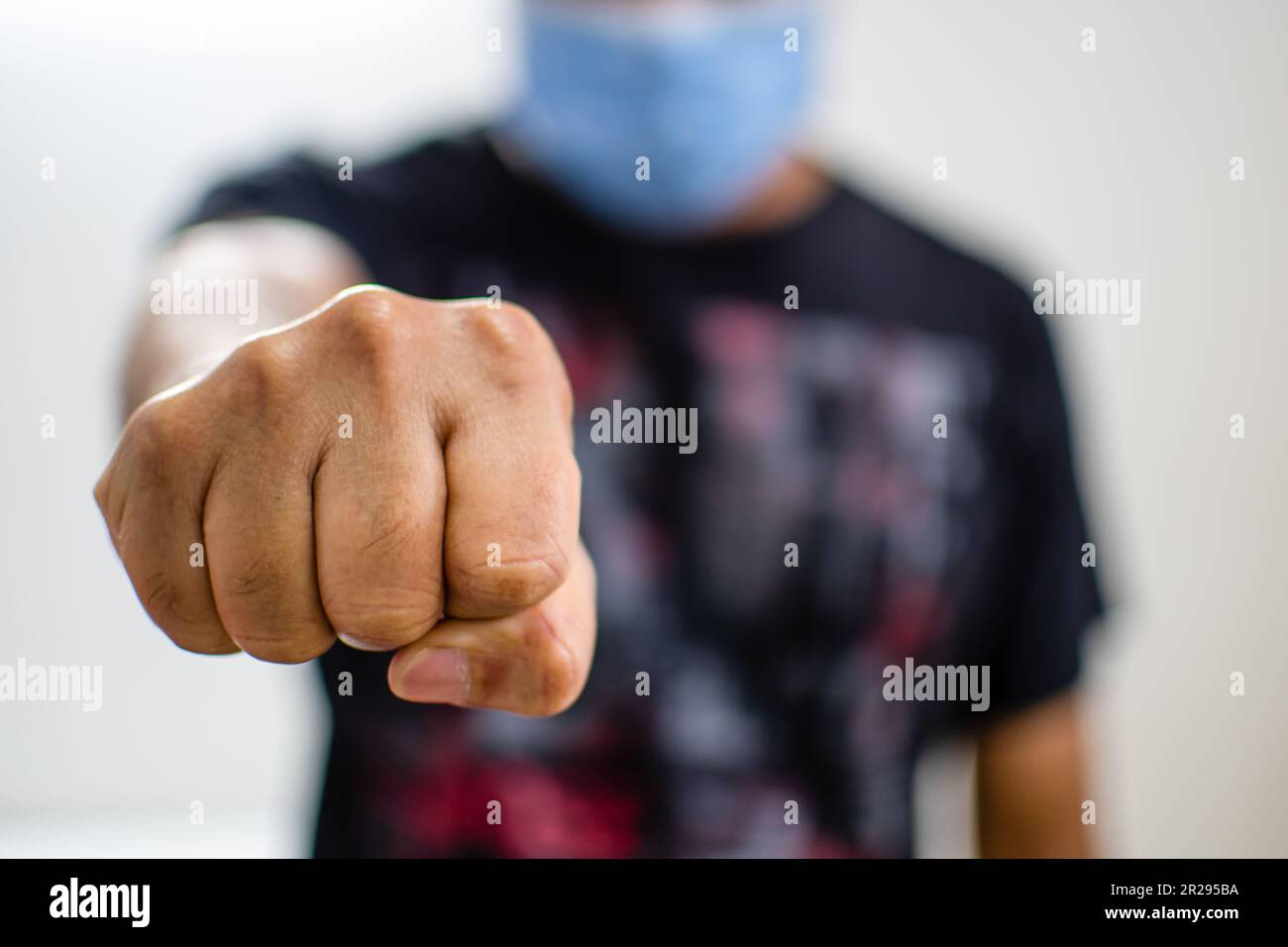 A young male is standing and fist clenched in anger. One man at home ...