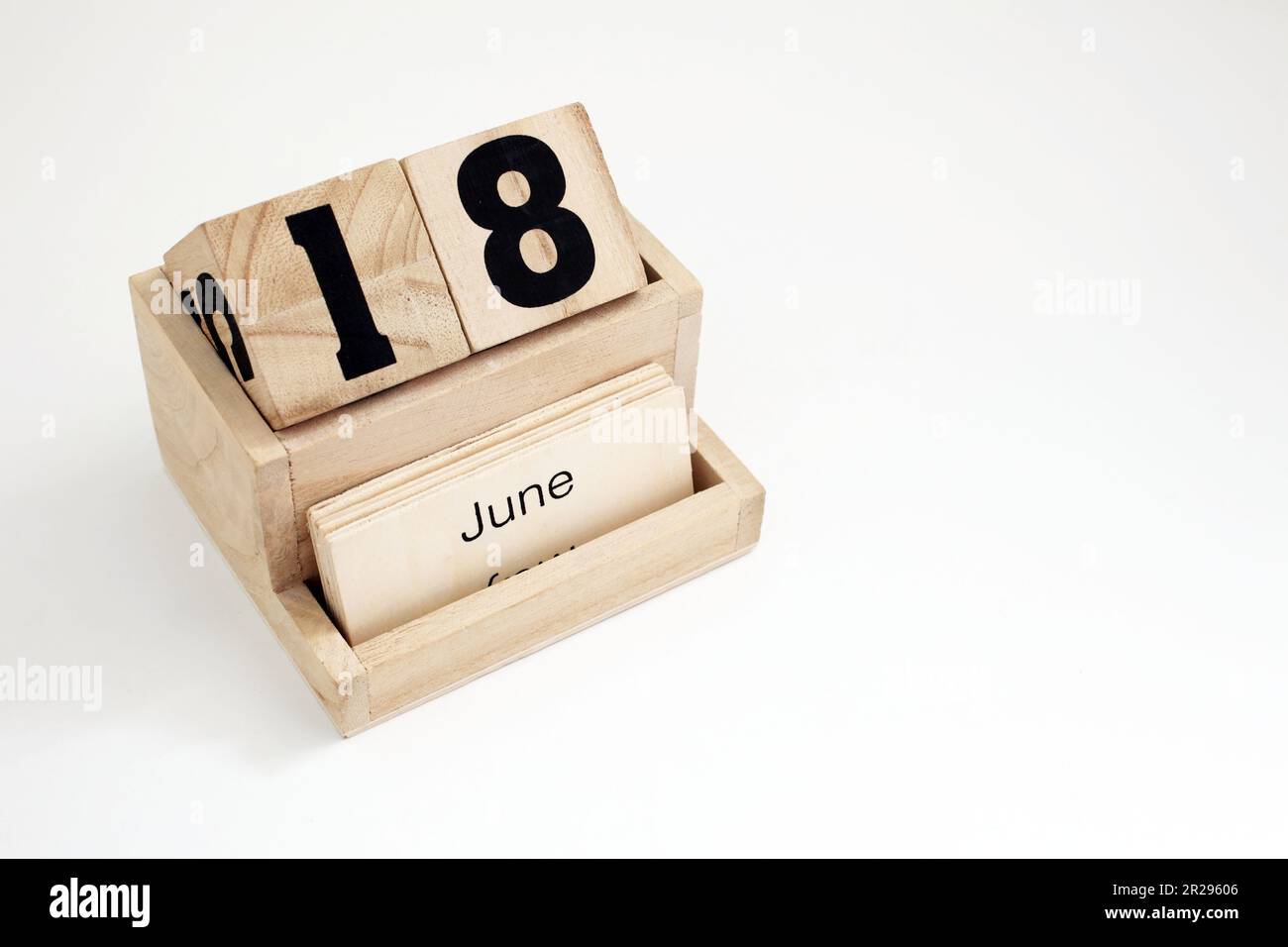 Wooden perpetual calendar showing the 18th of June Stock Photo - Alamy