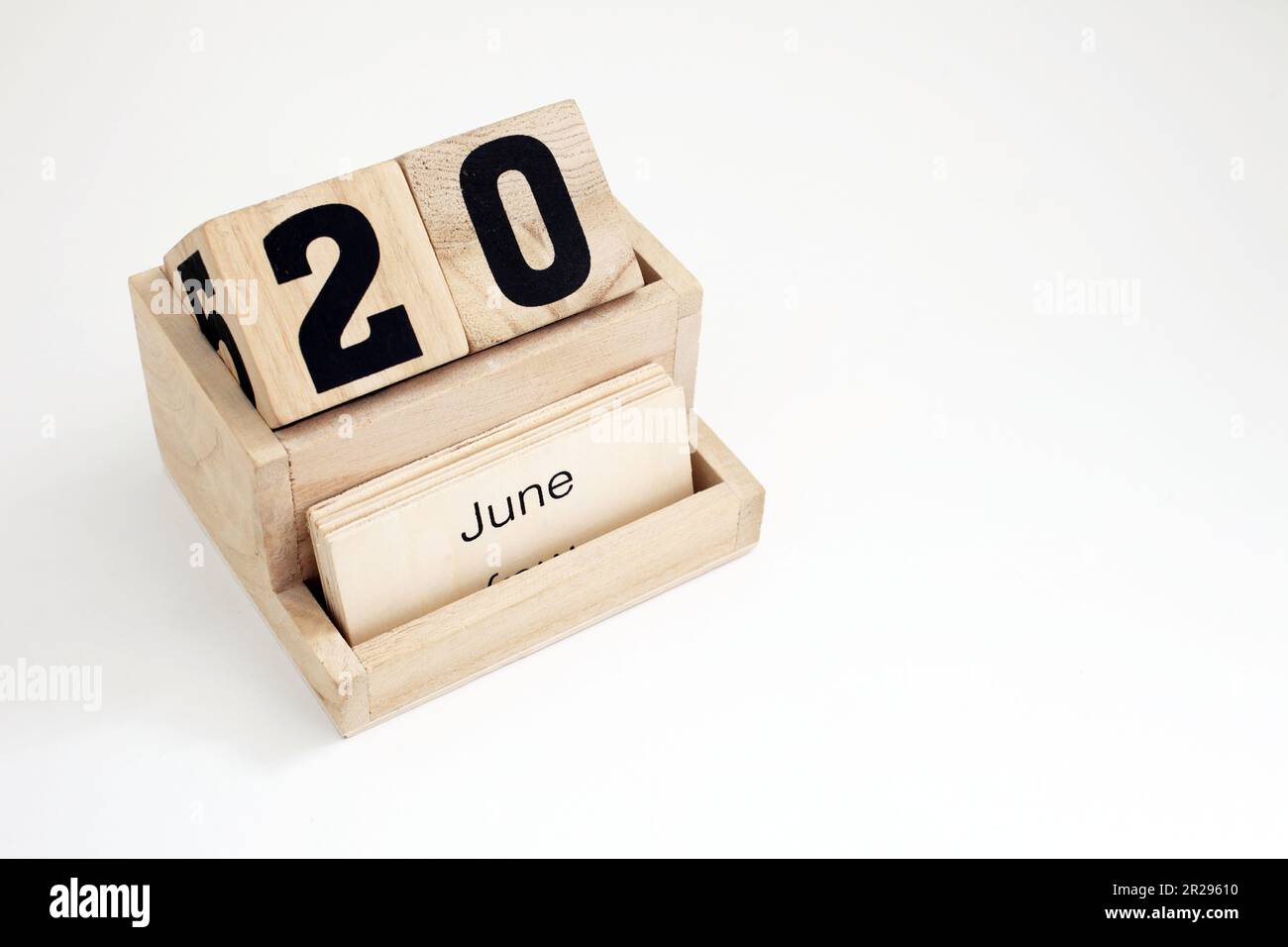 Wooden perpetual calendar showing the 20th of June Stock Photo - Alamy