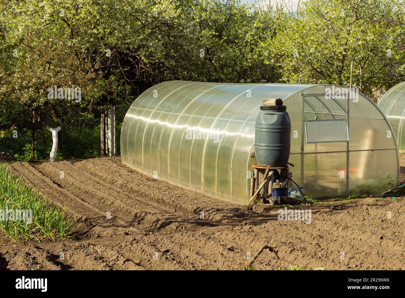 Beautiful vegetable garden with greenhouses potato beds and black soil ...