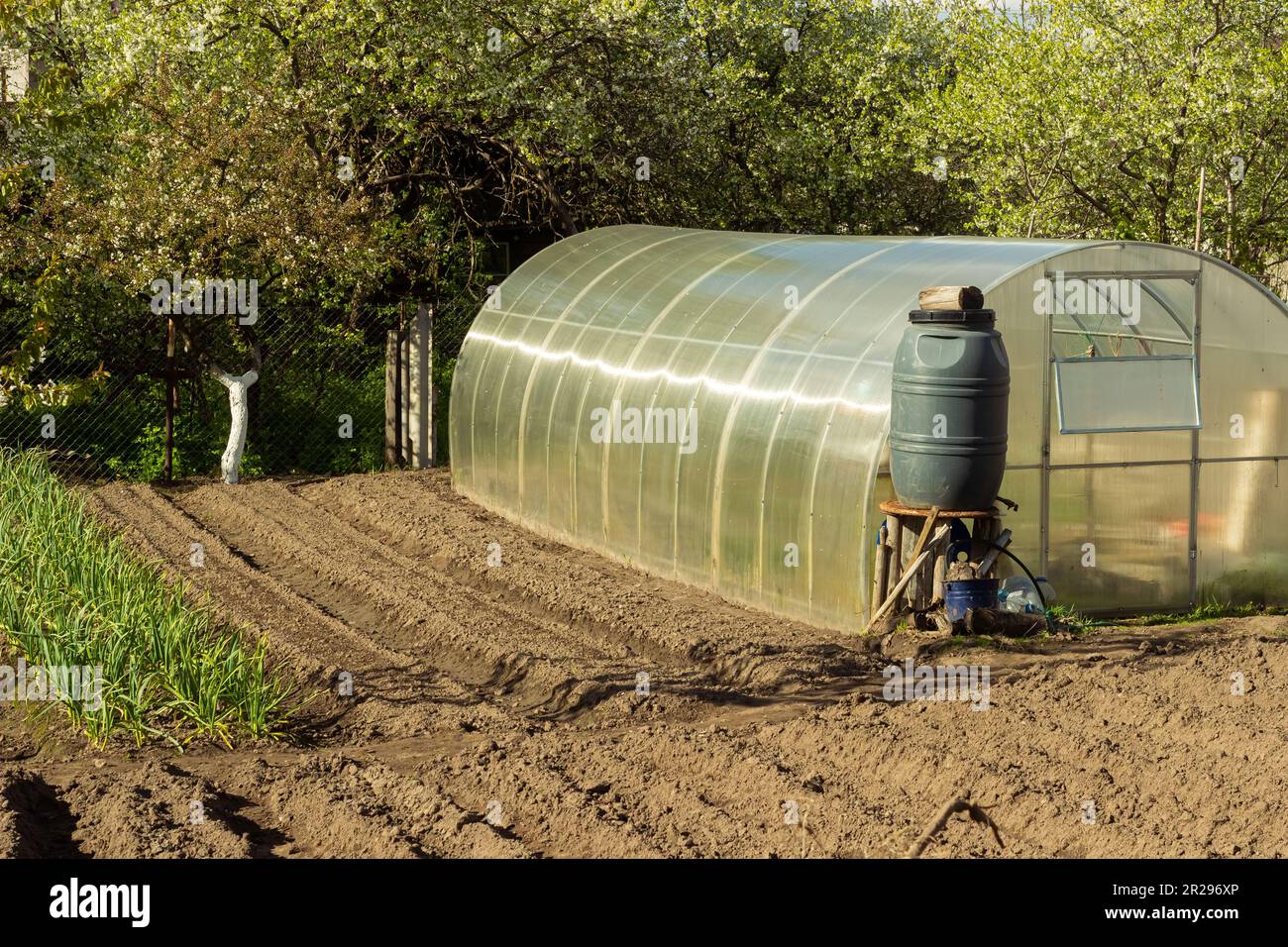 Beautiful vegetable garden with greenhouses potato beds and black soil ...