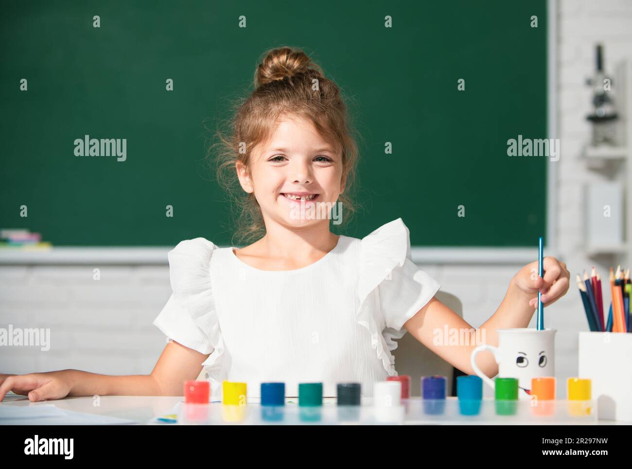 Cute little girl child painting with paints color and brush. Drawing ...