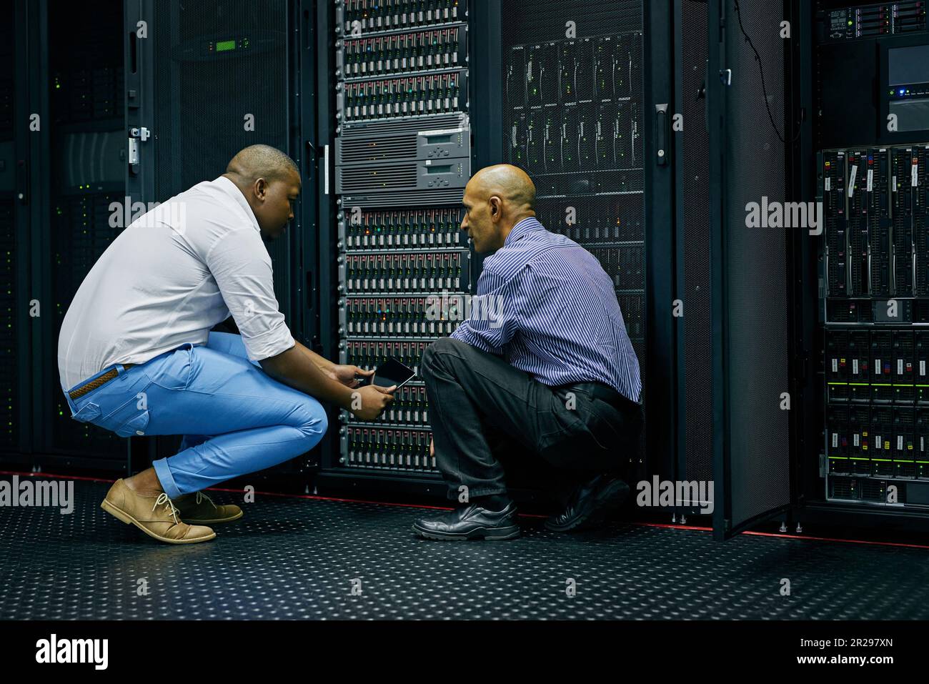 Server room, men or technicians talking about hardware together for a ...