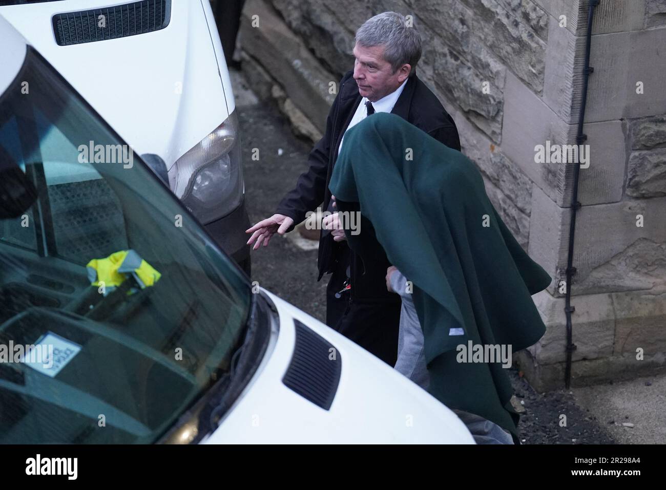 File photo dated 09/02/23 of Andrew Miller (covered) being led from ...