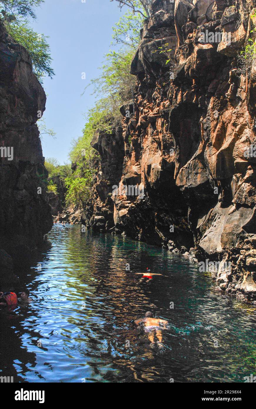 People snorkeling in Las Grietas, an ocean water pool positioned ...