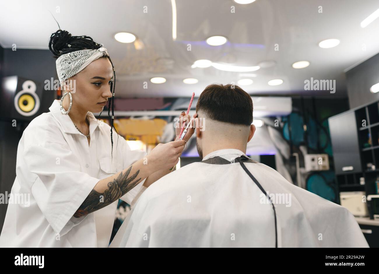 A barber cuts a man's hair in a barber shop. Men's professional hair ...
