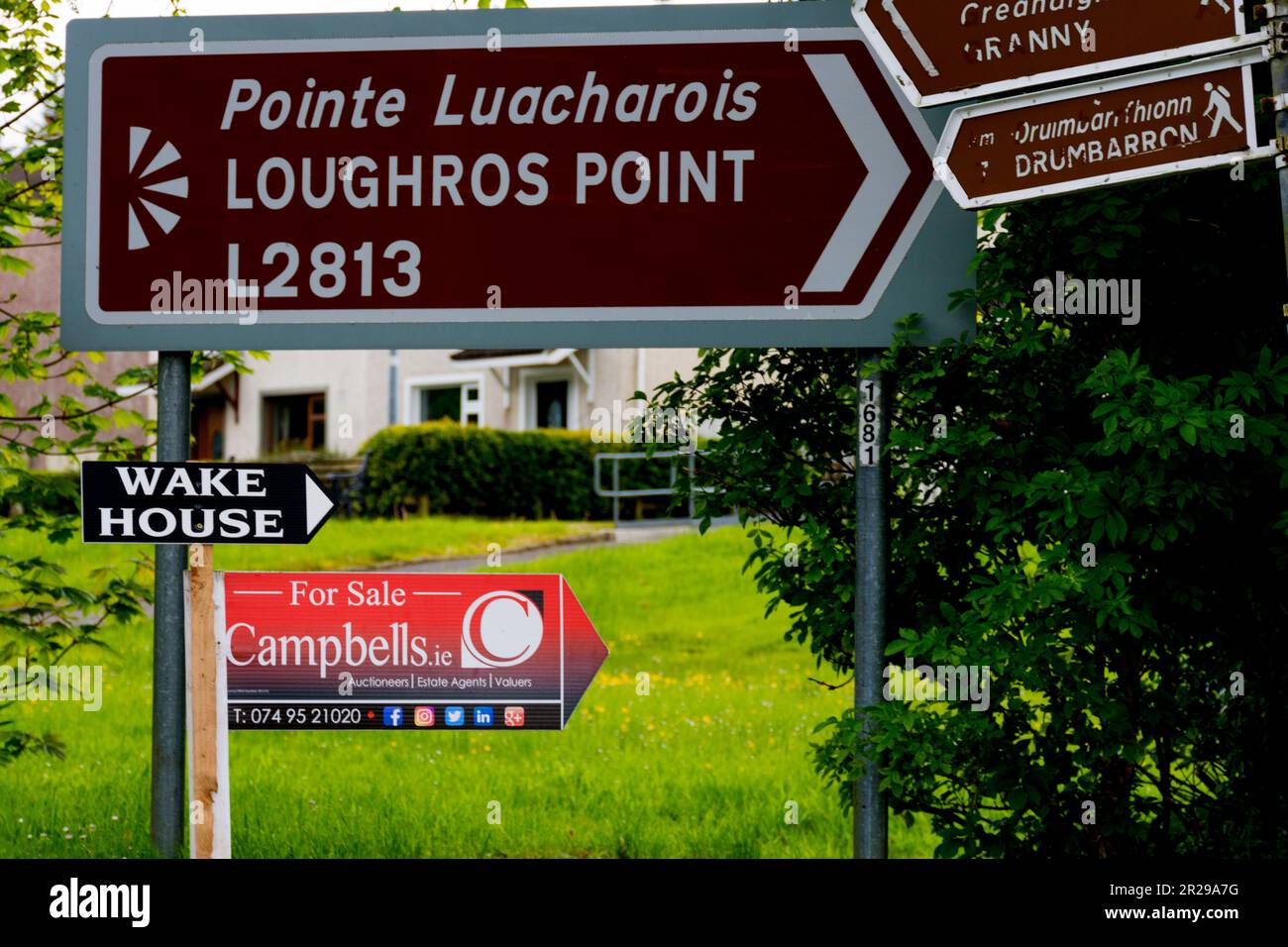 Wake House sign amongst other road signage in Ardara, County Donegal ...