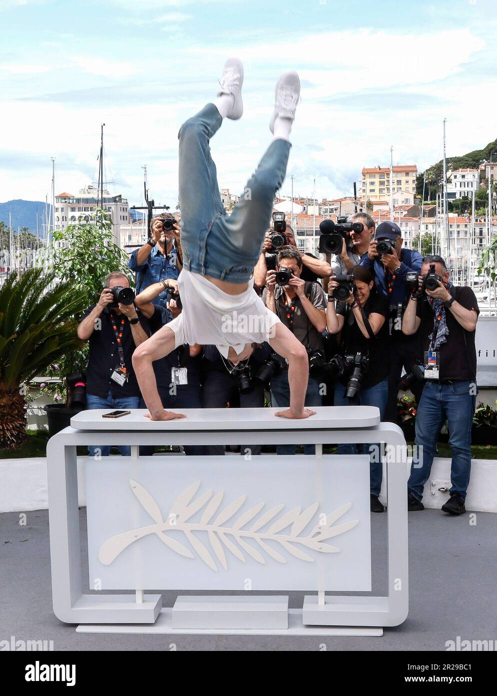 Tom Mercier performs a handstand at the photo call for the film 'Le ...