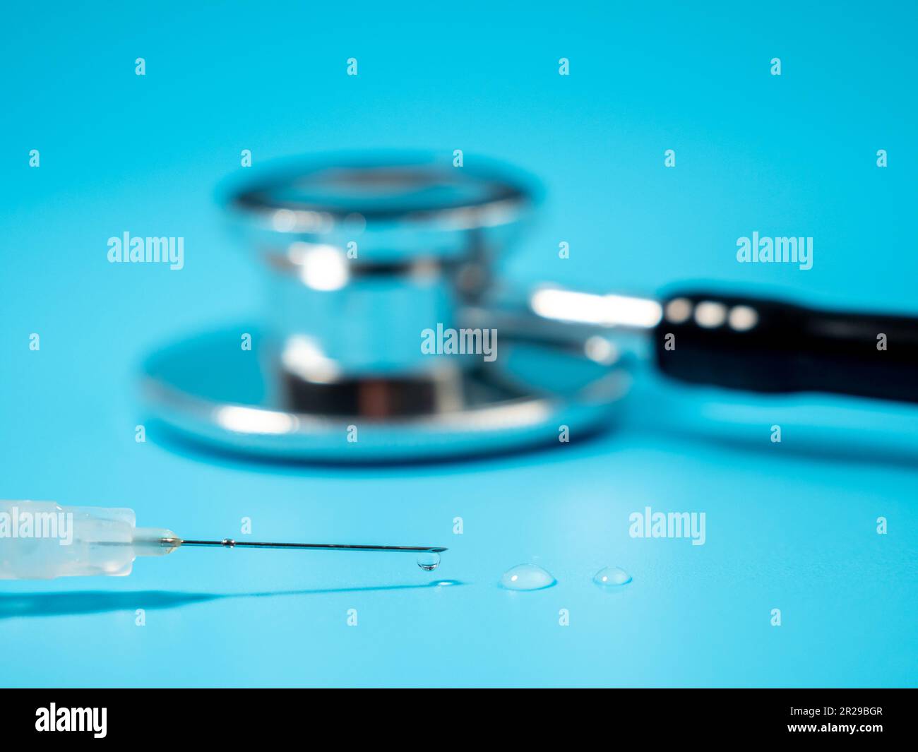 Injection vaccine on a blue background, medicine concept. On the ...