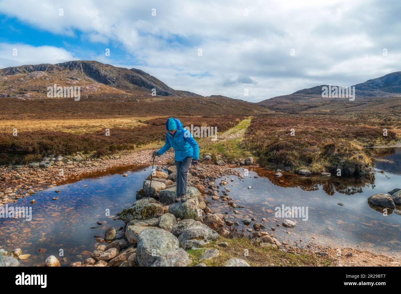 Crossing the Stepping Stones over The Allt Smoo near Durness in ...