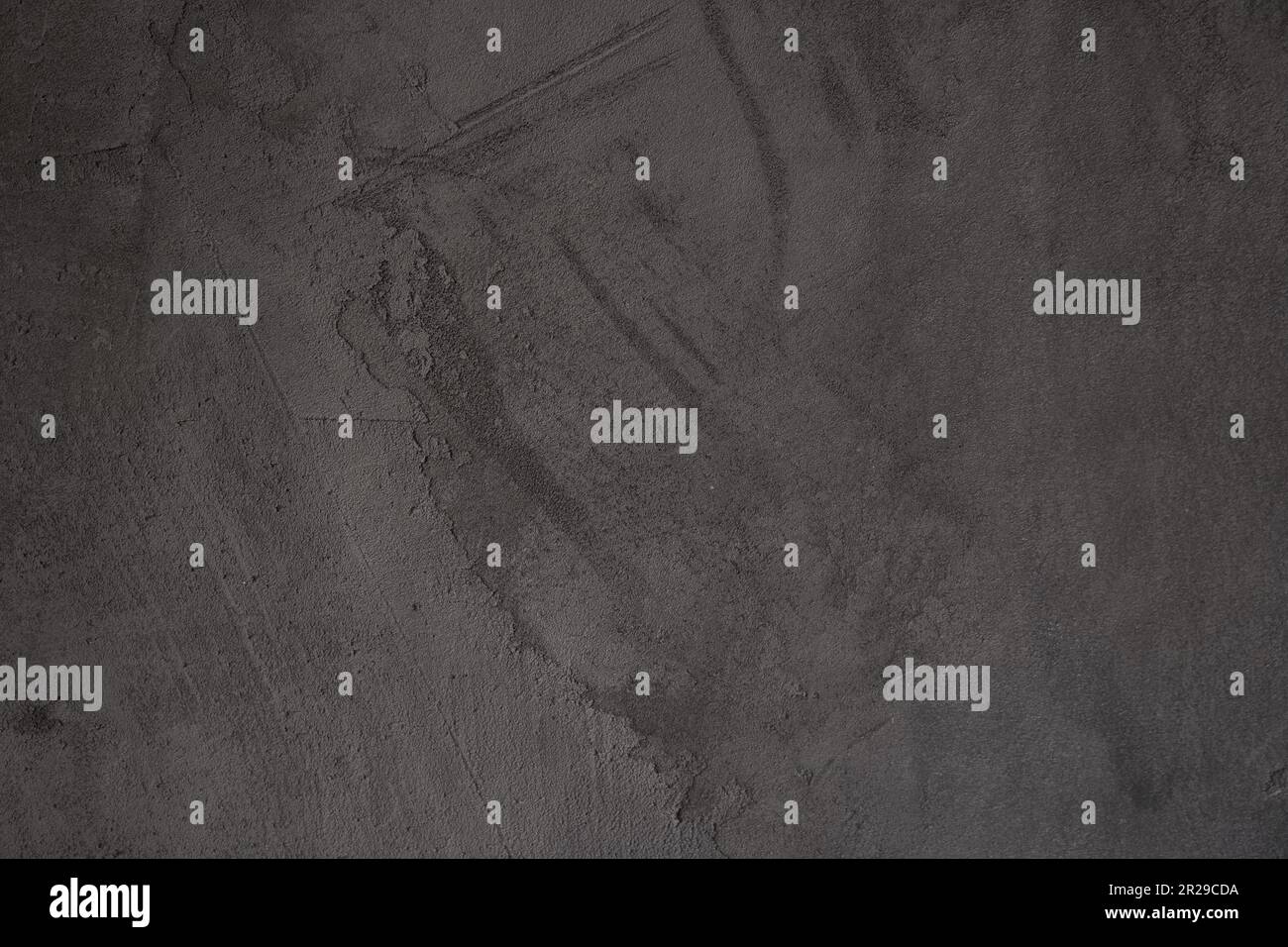 The dark surface is made of an old stone slab with an uneven natural ...