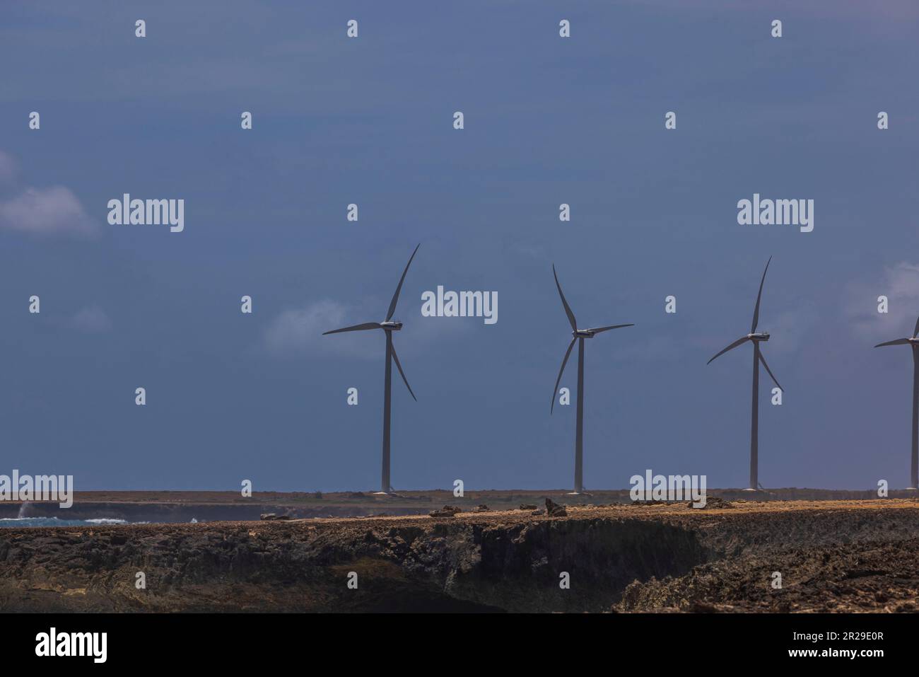 View of wind turbines in desert, on Caribbean coast against blue sky ...