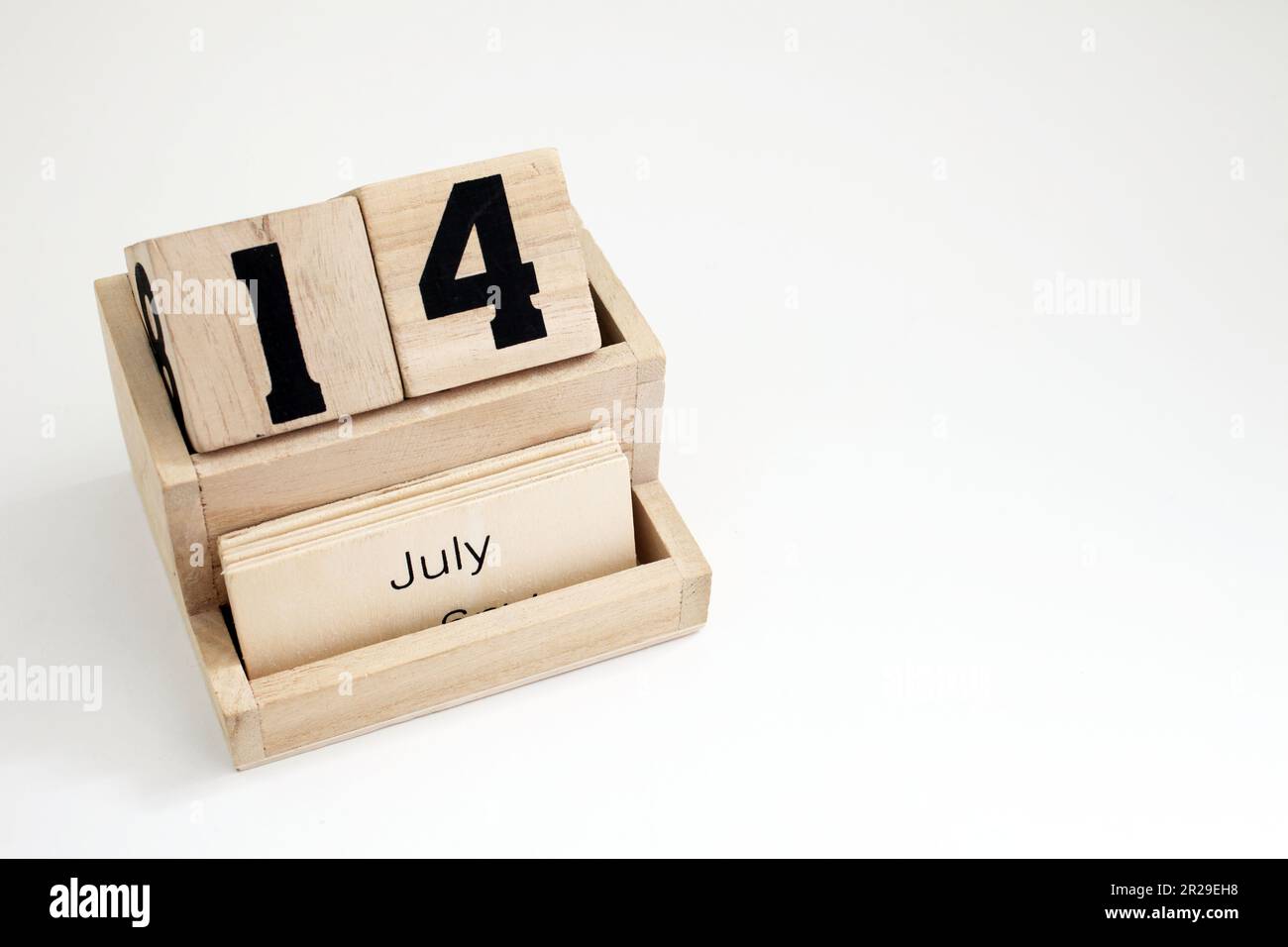 Wooden perpetual calendar showing the 14th of July Stock Photo - Alamy