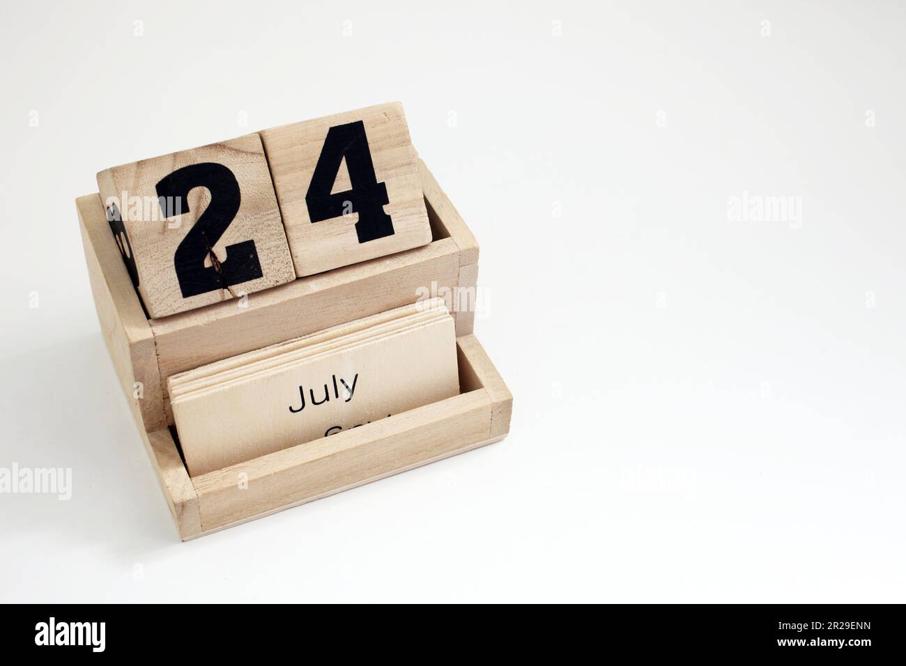 Wooden perpetual calendar showing the 24th of July Stock Photo - Alamy