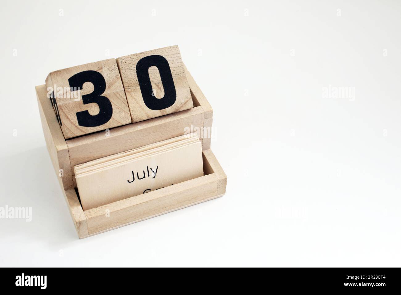 Wooden perpetual calendar showing the 30th of July Stock Photo - Alamy