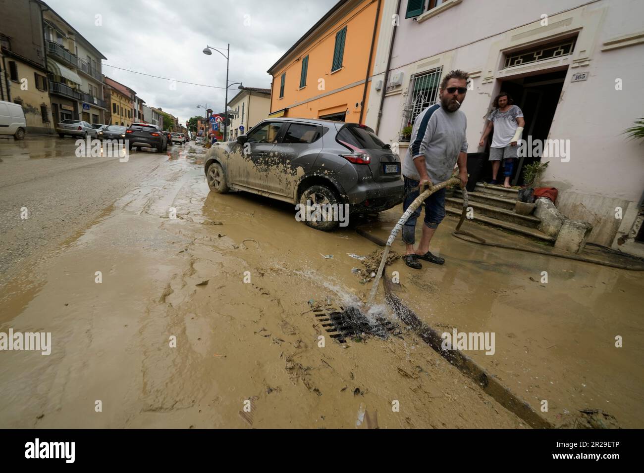A man removes water from his flooded home in Castel Bolognese, Italy ...