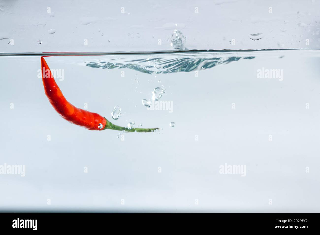 chilli drop water splashes Stock Photo - Alamy