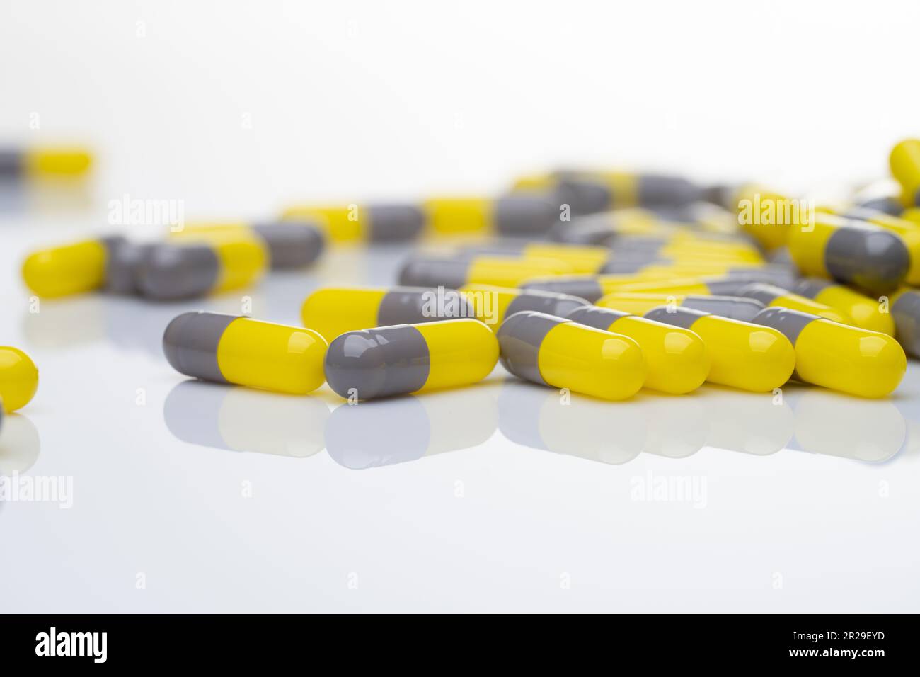 Yellow and gray probiotic capsule pill on white background. Probiotic ...