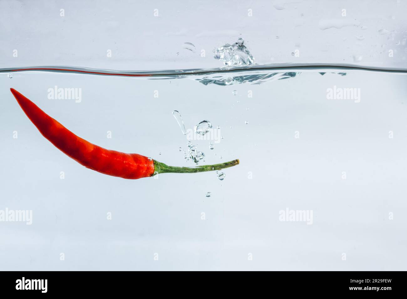 chilli drop water splashes Stock Photo - Alamy