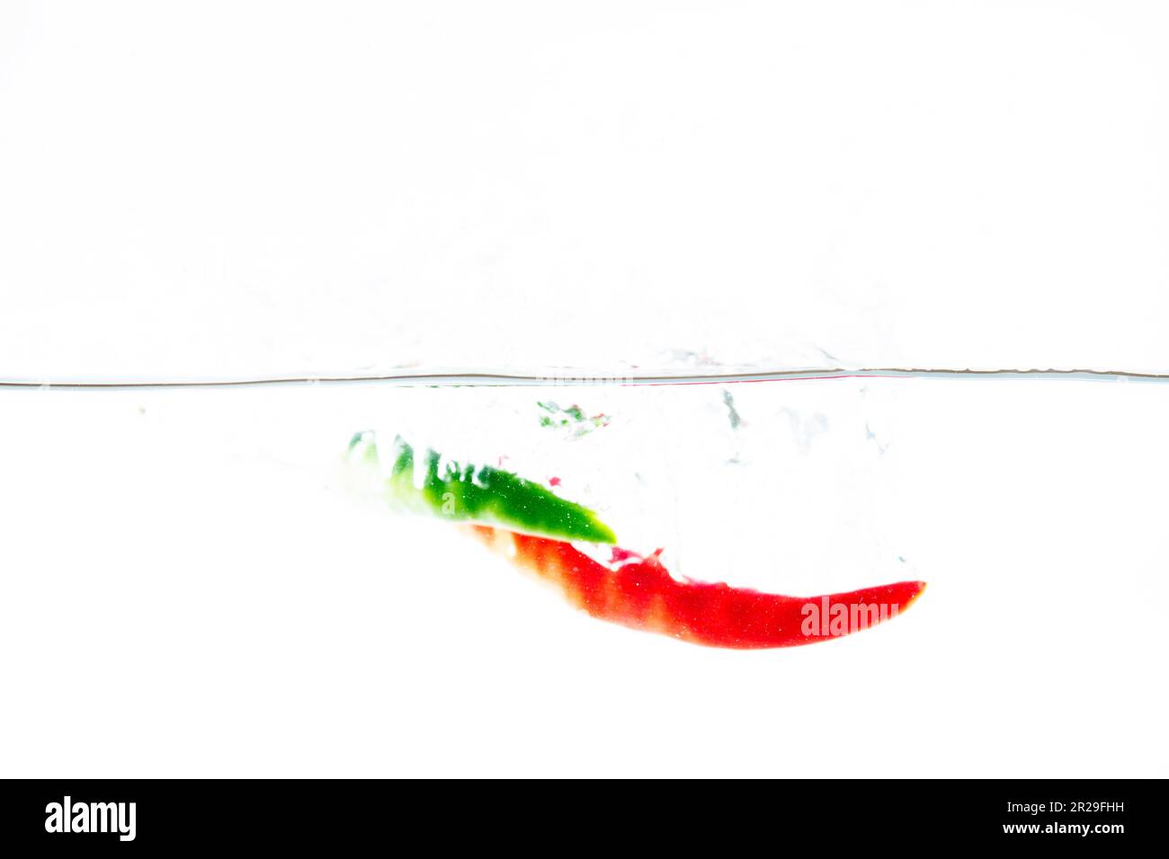 chilli drop water splashes Stock Photo - Alamy