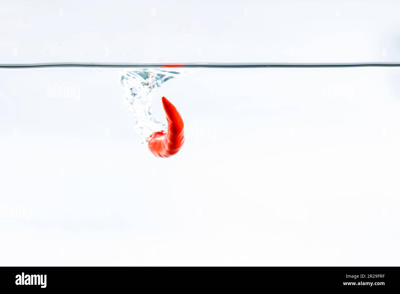 chilli drop water splashes Stock Photo - Alamy