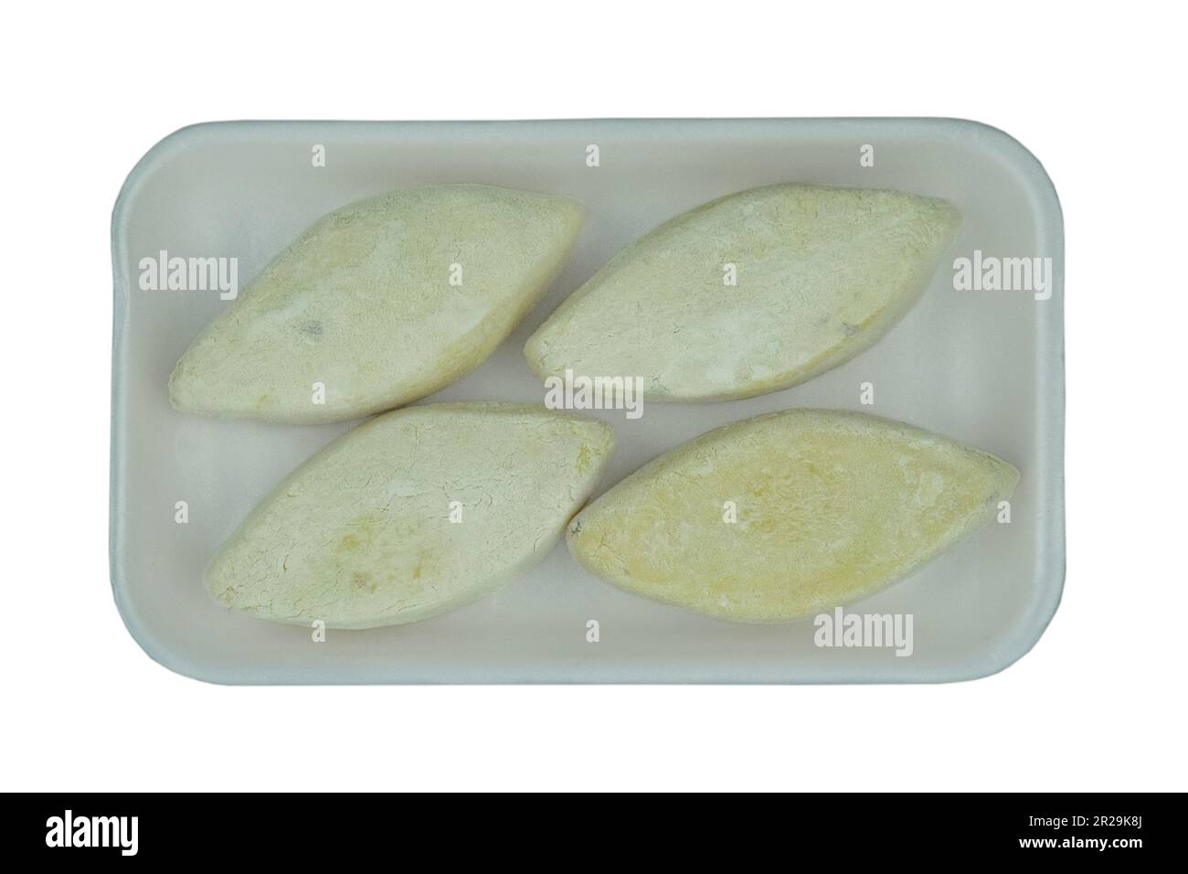 Raw potato rissoles on a cutting board isolated on white background ...