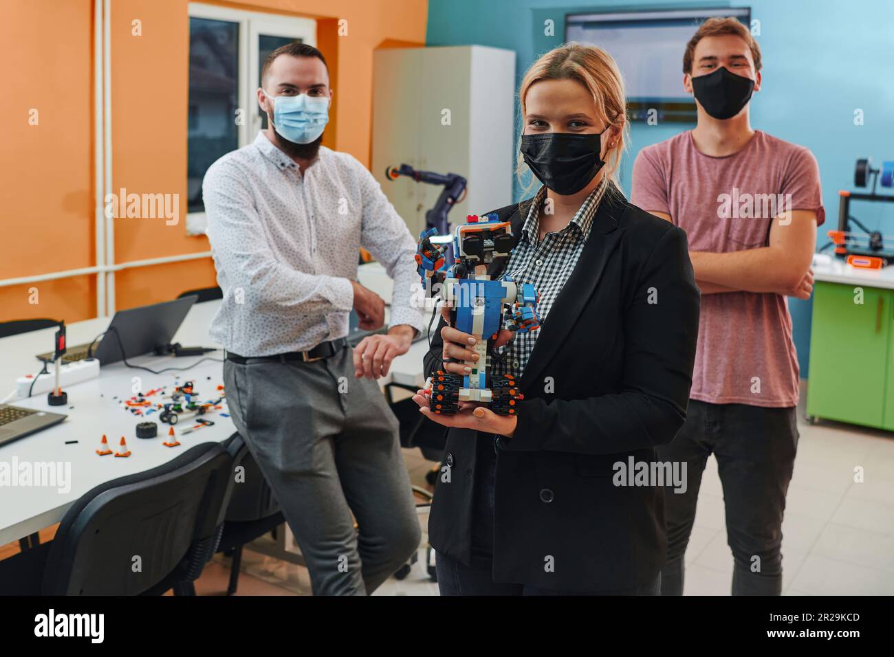 A group of colleagues working together in a robotics laboratory ...