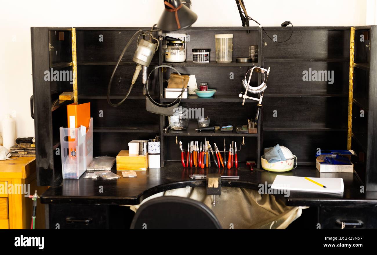 Interior of jewellery workshop with black desk, shelves and tools Stock ...