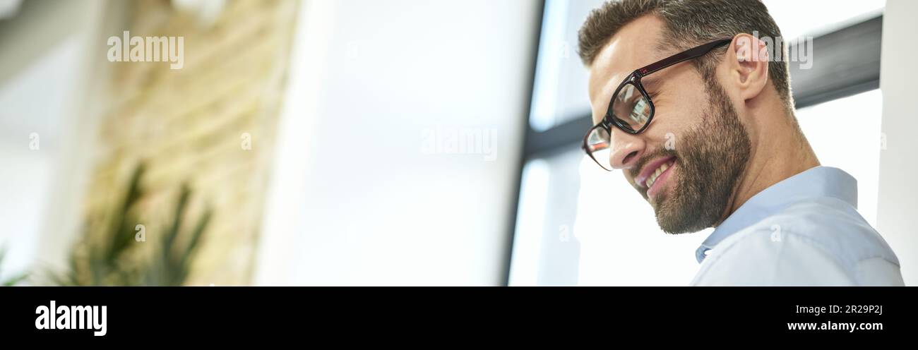 Cheerful office employee with modern gadget at work Stock Photo - Alamy