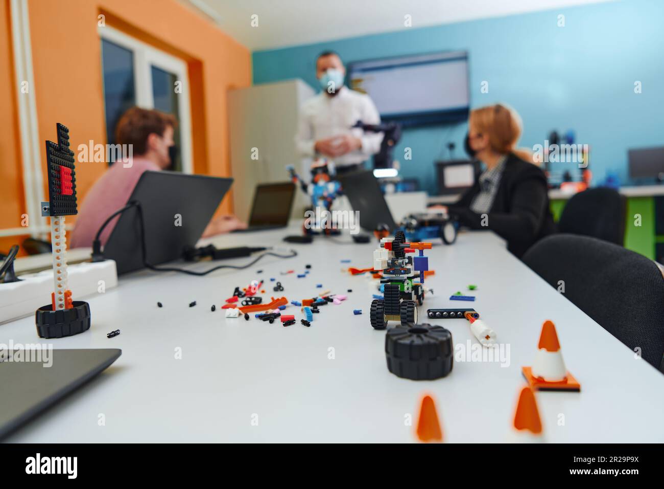 A group of colleagues working together in a robotics laboratory ...