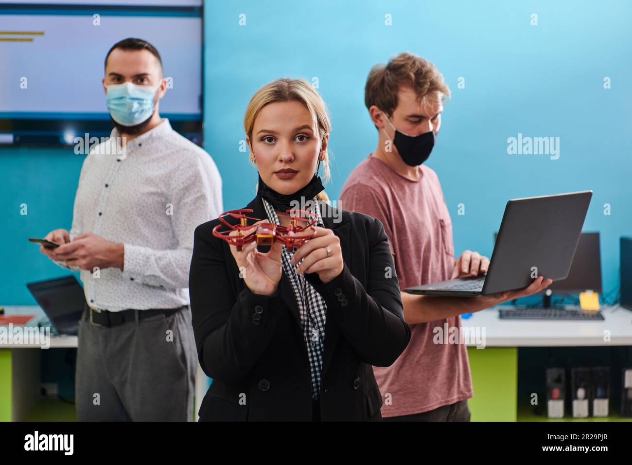 A group of students working together in a laboratory, dedicated to ...