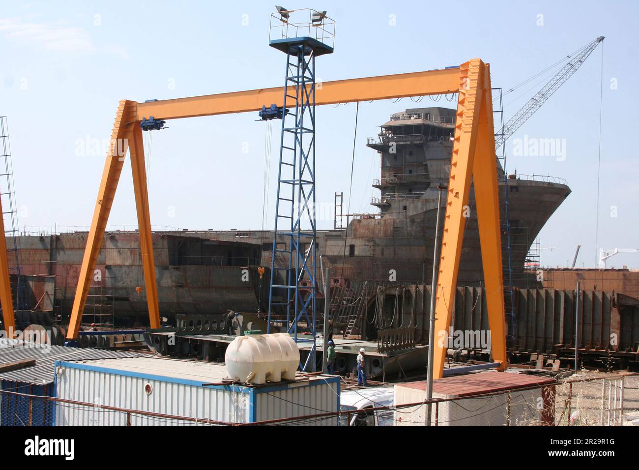 Shipbuilding pier and crane. Workers working on the pier Stock Photo ...