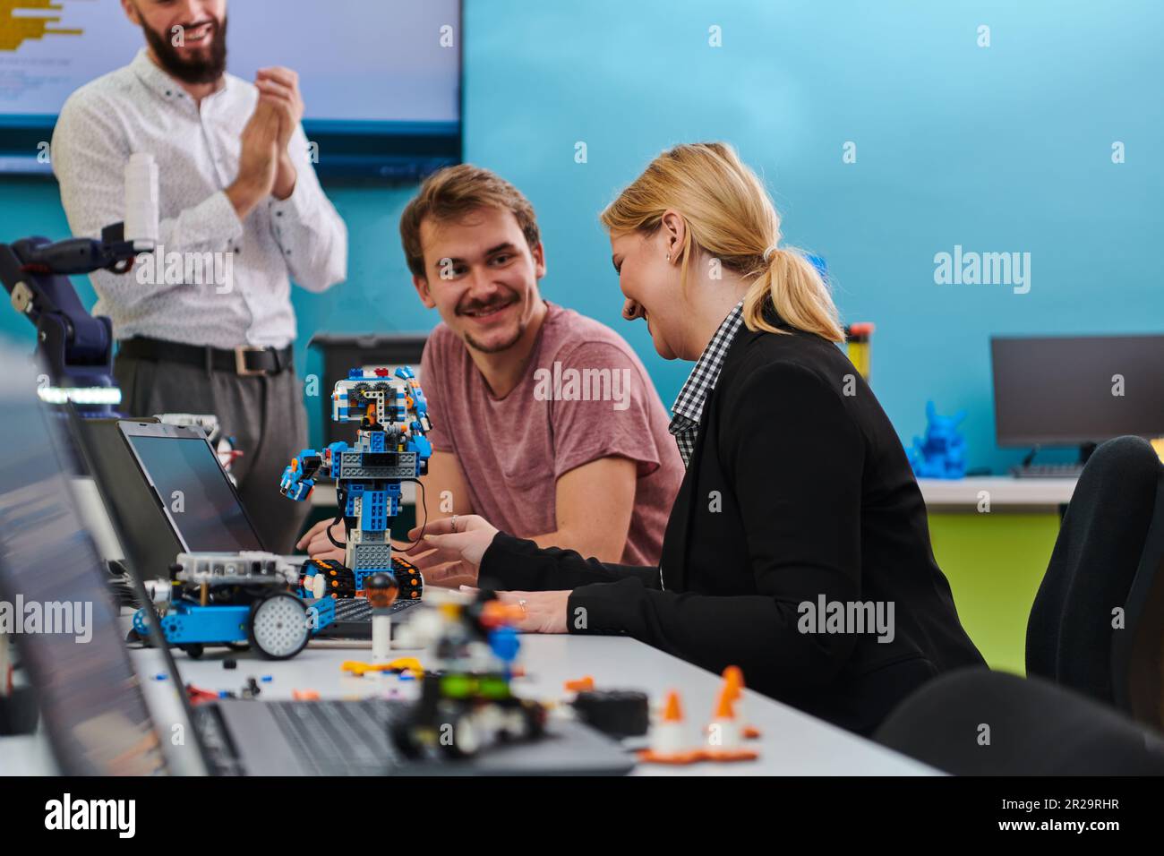 A group of colleagues working together in a robotics laboratory ...