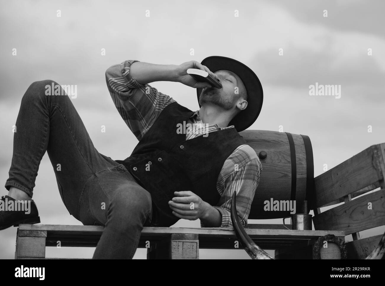 Cowboy drinking whiskey Black and White Stock Photos & Images - Alamy