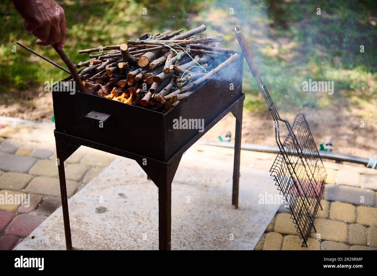 Close-up tree branches with a blazing fire to start a fire in a ...