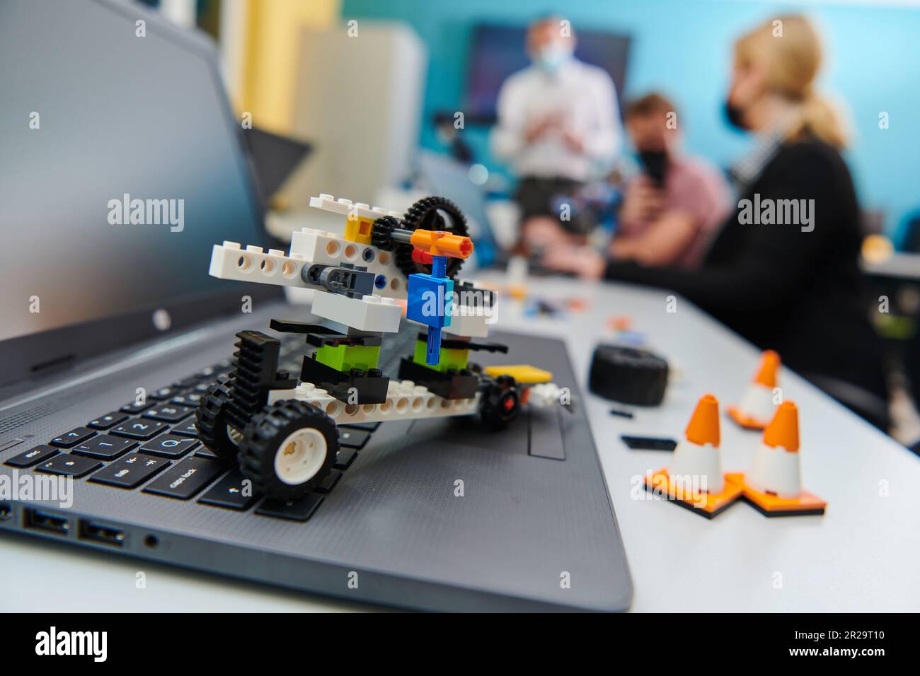 A group of colleagues working together in a robotics laboratory ...