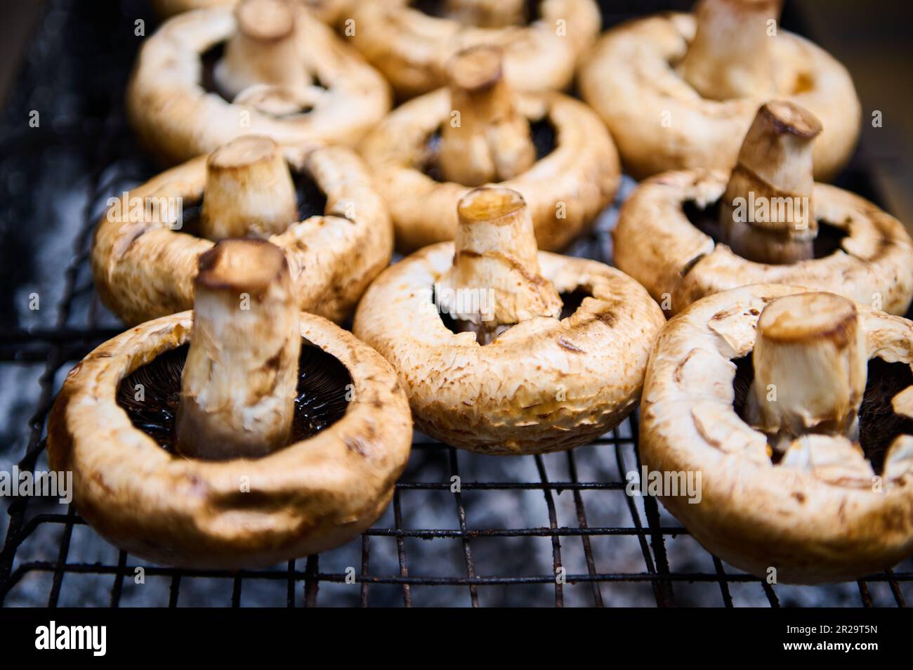 Close-up view seasoned marinated brown champignon portobello mushrooms ...