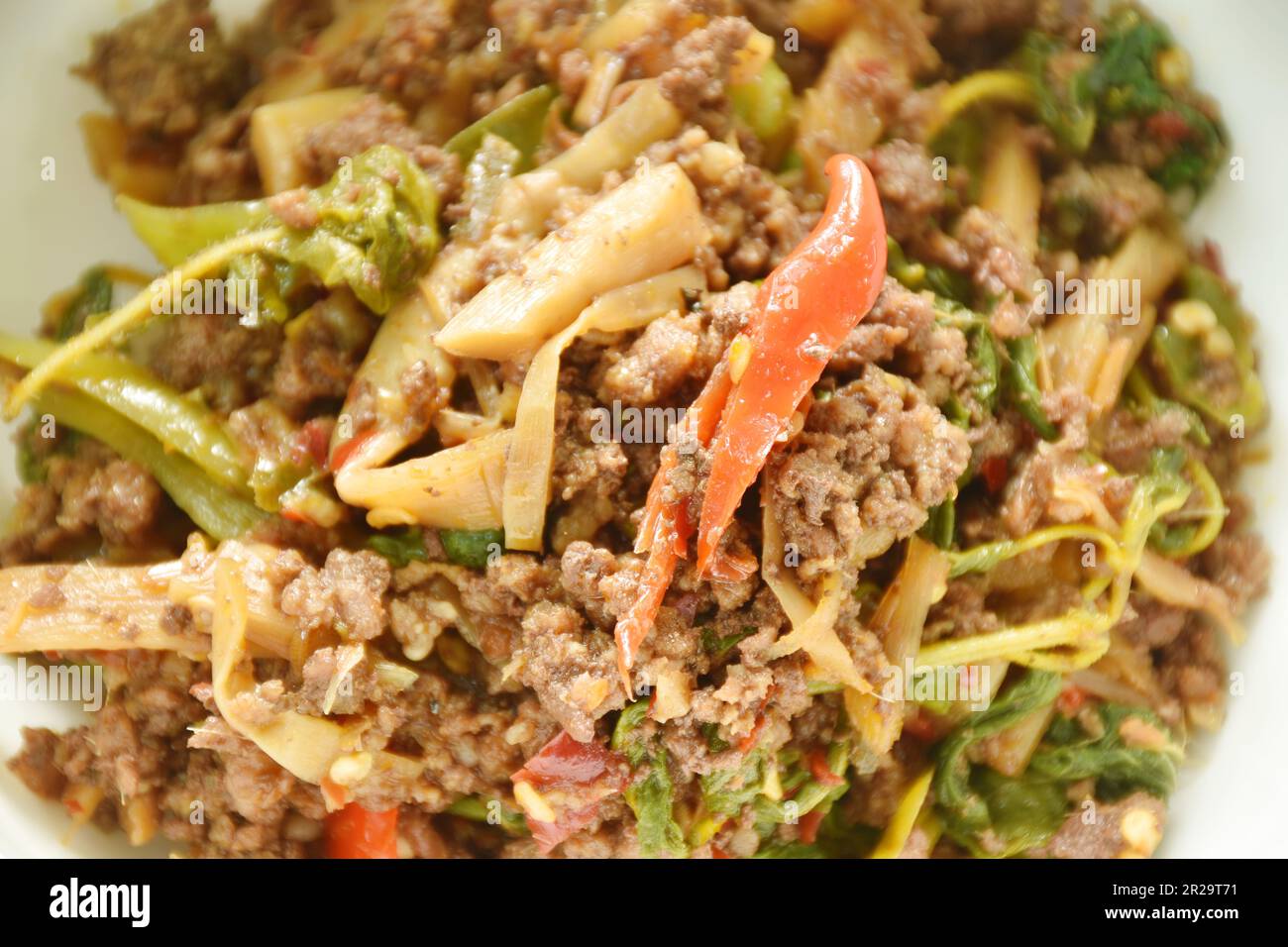 spicy stir fried bamboo shoot and chop beef meat with basil leaf in ...